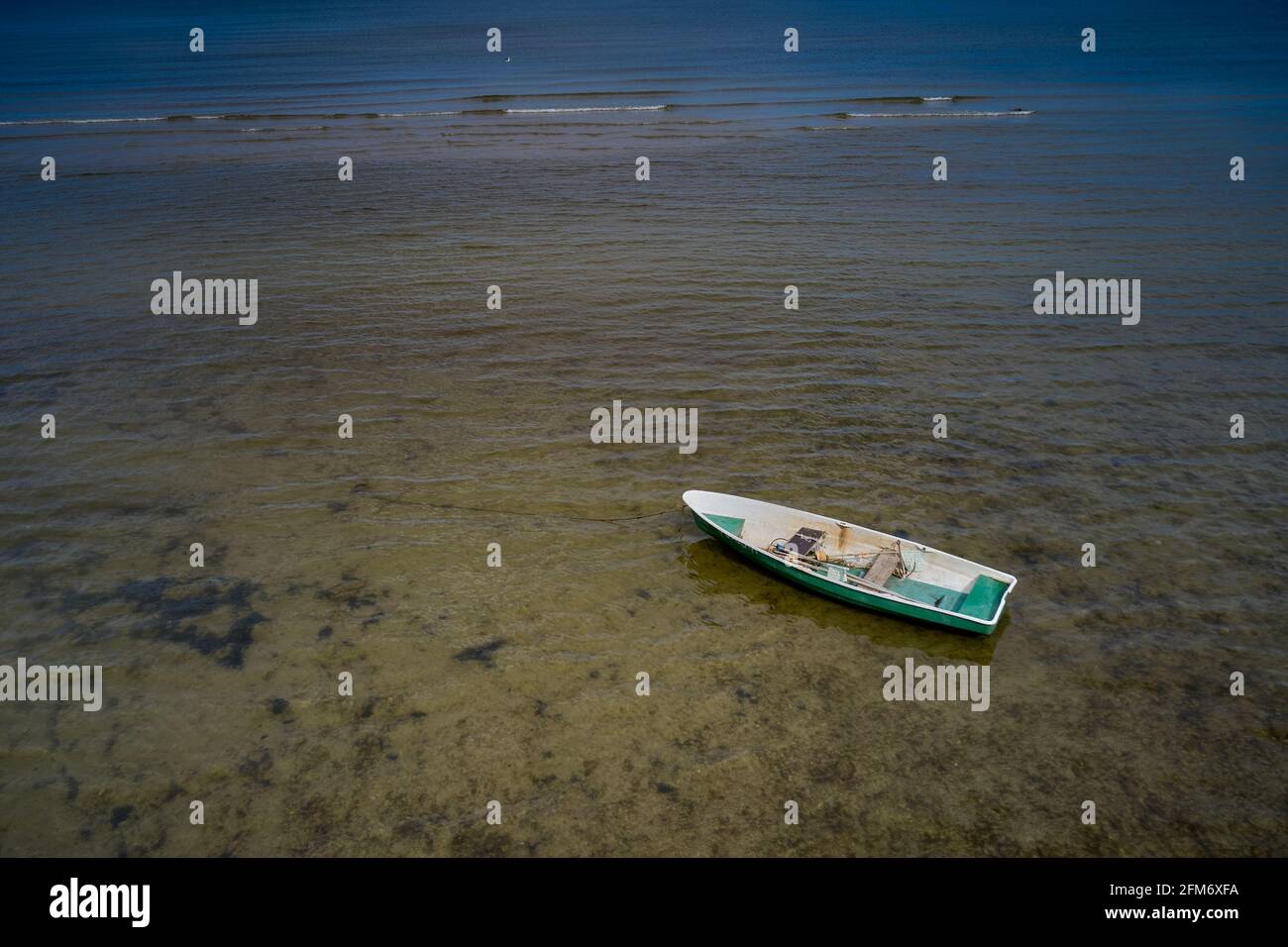 Small fishing boat floating on the water Stock Photo - Alamy