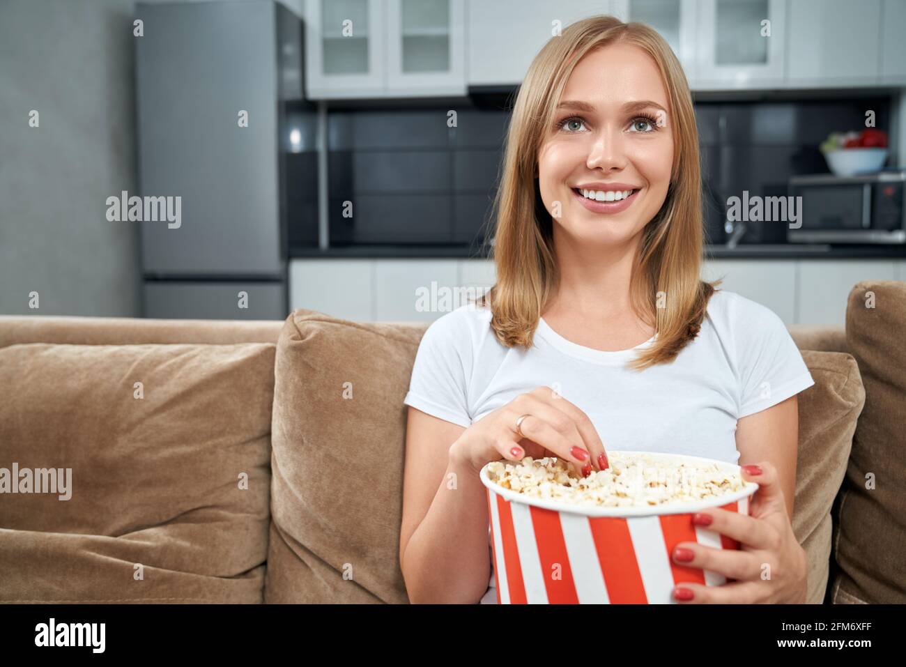 Movie sofa watching popcorn hi-res stock photography and images - Alamy