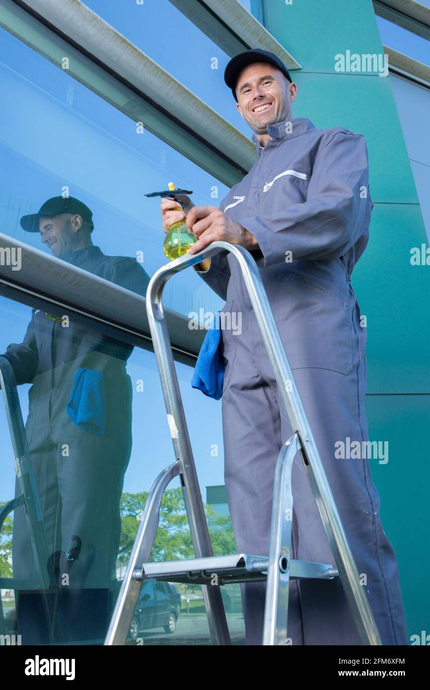 a glass window cleaner smiling Stock Photo - Alamy