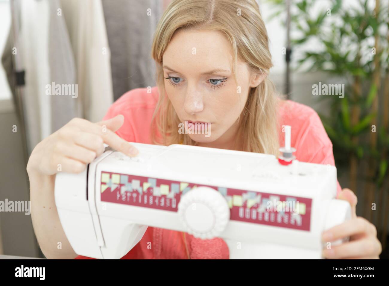 woman tailoring boot on sewing-machine Stock Photo - Alamy