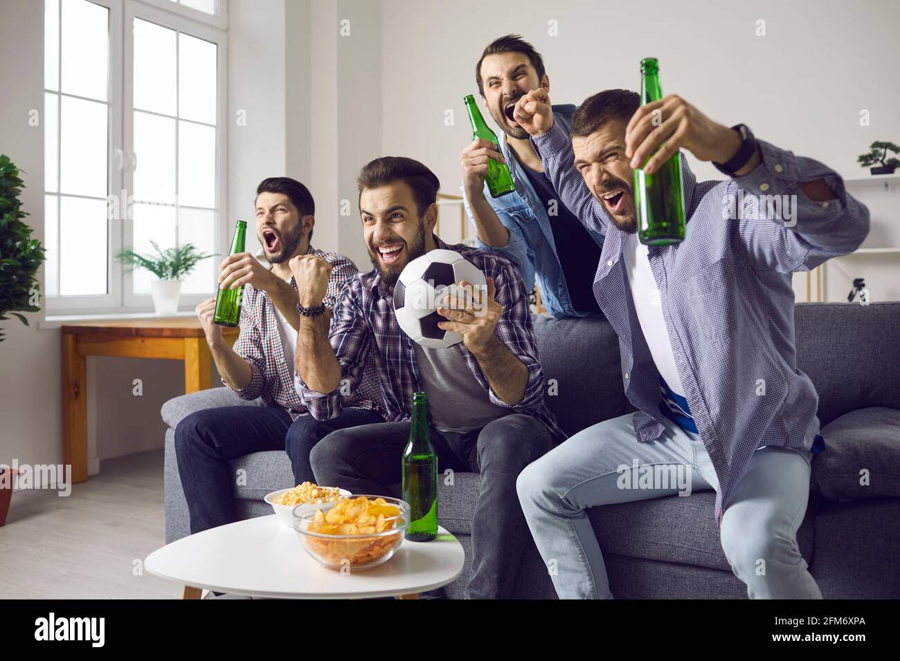 Sport fans watching football game hi-res stock photography and images ...