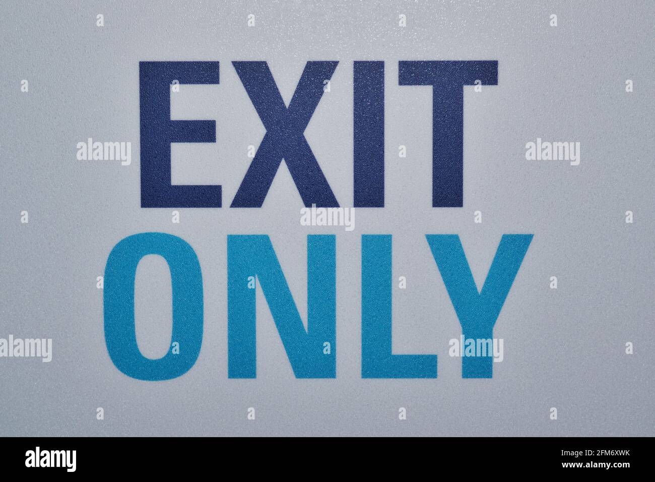 Exit Only sign, blue capital English lettering on white background ...