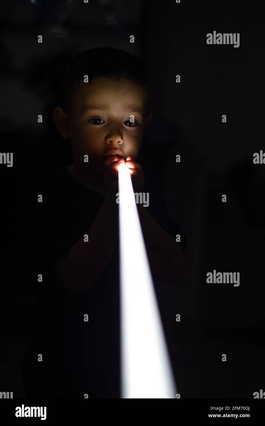 Portrait of child boy playing with a led bar light Stock Photo - Alamy