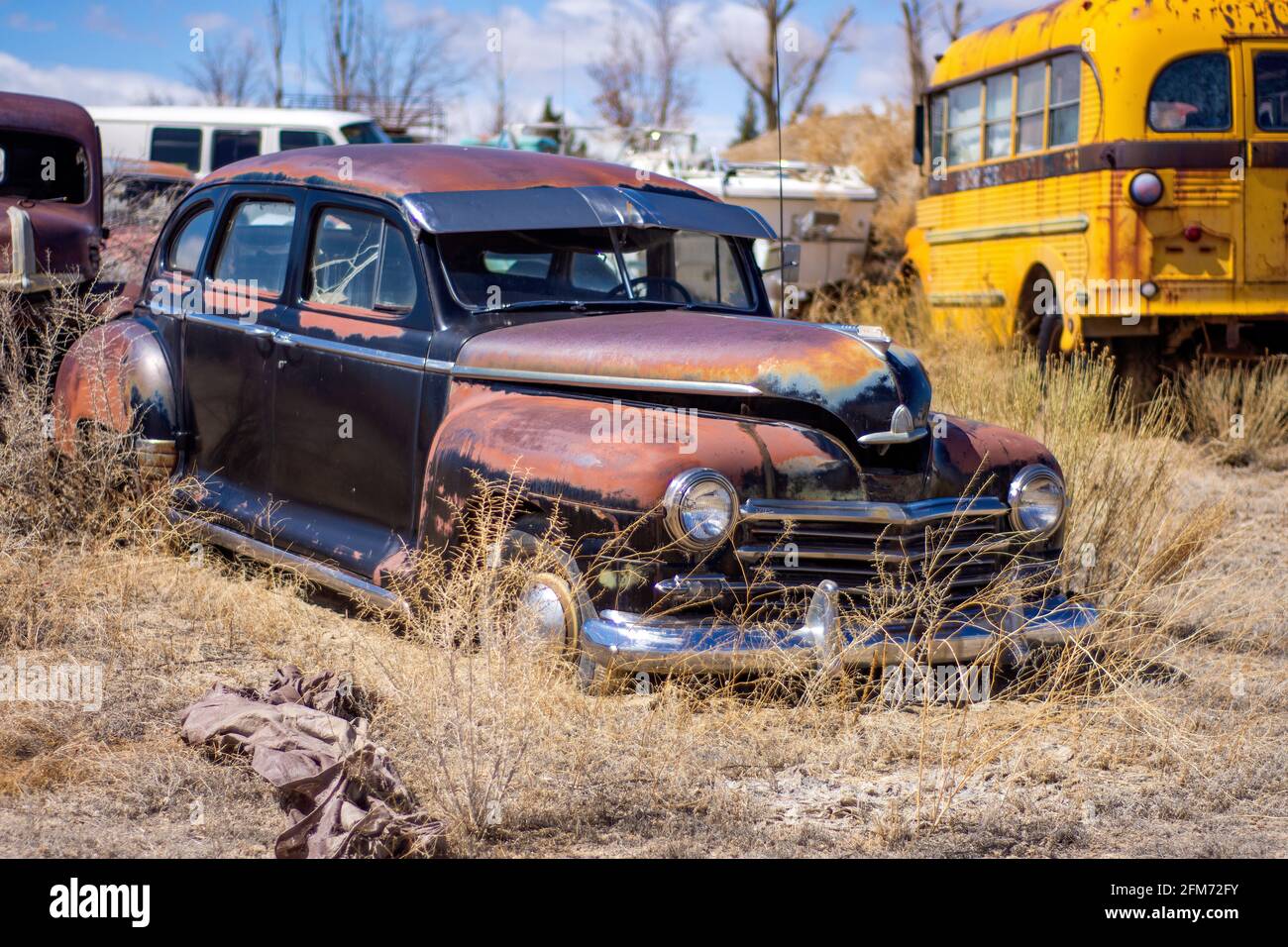 Retro rusty black car in the junkyard Stock Photo - Alamy