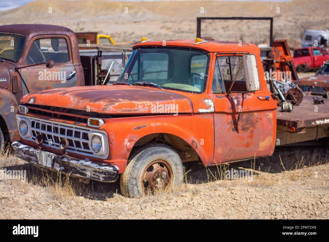 Rusty red truck in the junkyard Stock Photo - Alamy