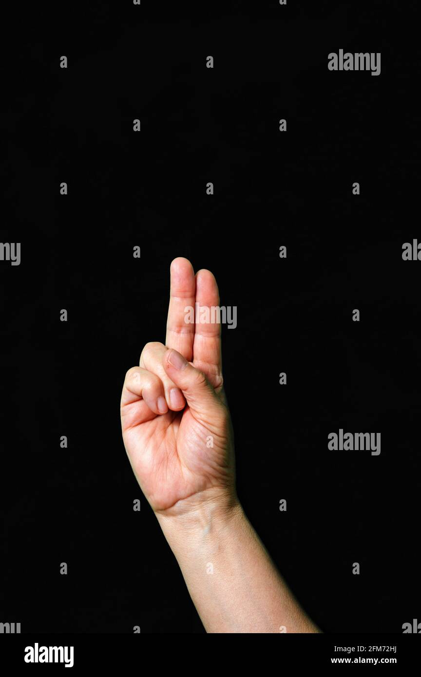 Hand making and showing Letter U International sign language dark ...