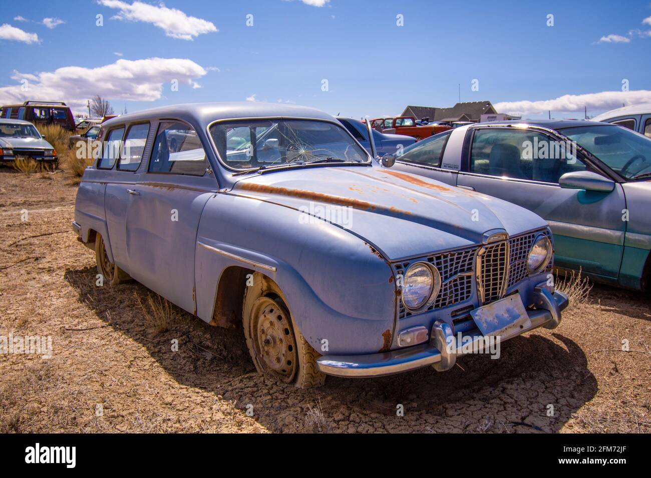 Old retro blue car in the junkyard Stock Photo - Alamy