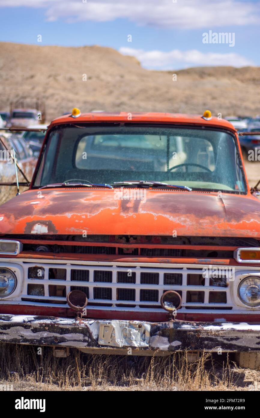Front of the red rusty car in the junkyard Stock Photo - Alamy
