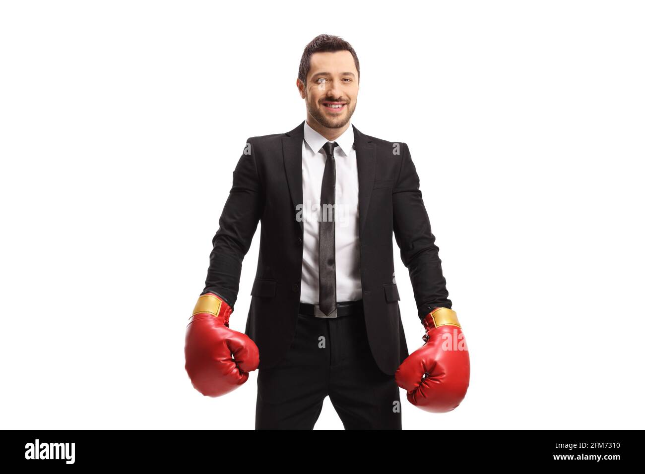 Man in a suit and tie wearing boxing gloves and smiling at the camera ...
