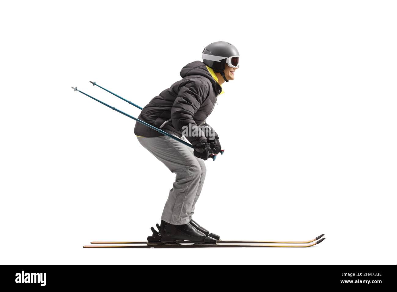 Full length profile shot of a man skiing isolated on a white background ...