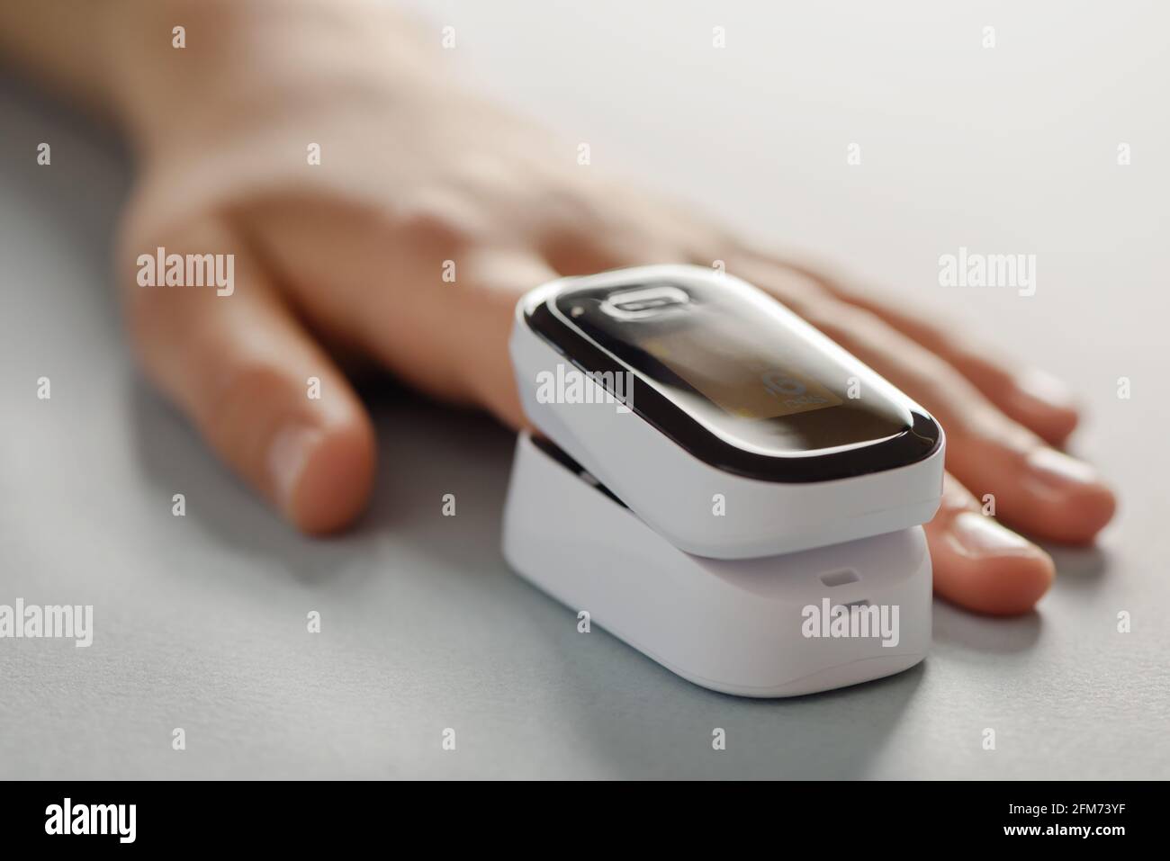 Measuring the amount of oxygen in blood with a pulse oximeter Stock ...