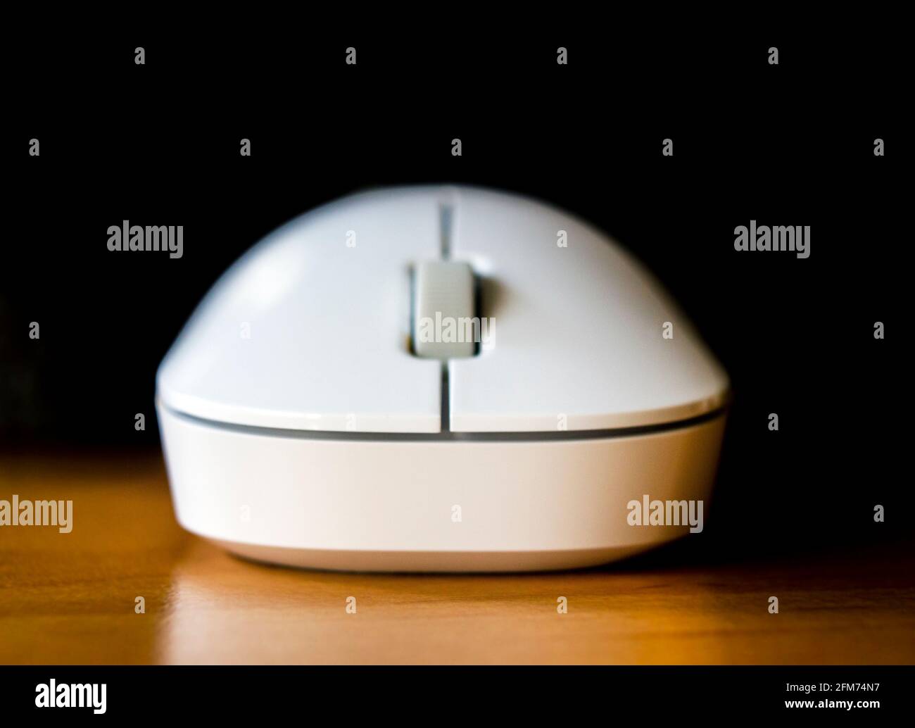 Front view close up of an aerodynamic shaped white computer mouse or ...