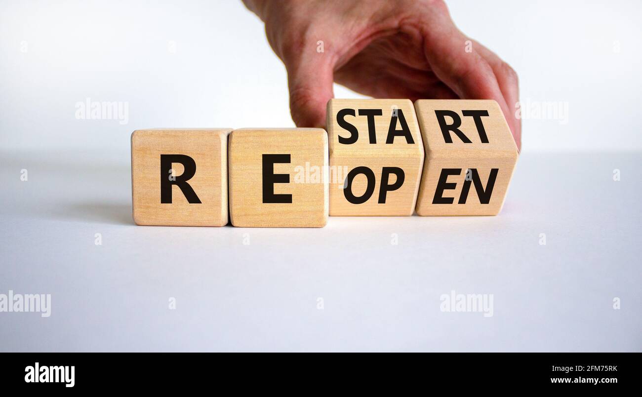 Reopen and restart symbol. Businessman hand turns cubes and changes the ...