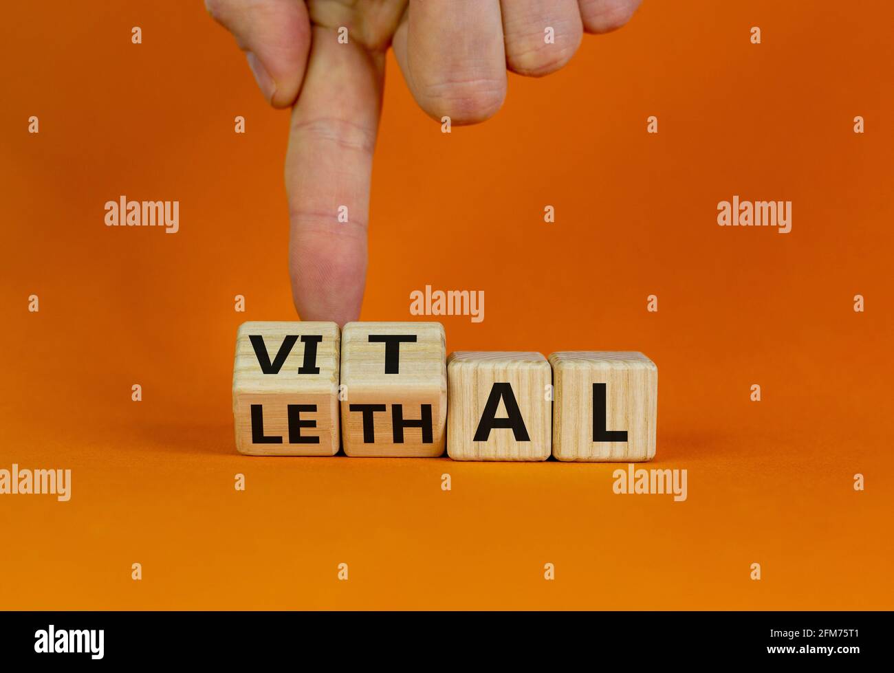 Vital vs lethal symbol. Businessman turns wooden cubes and changes the ...