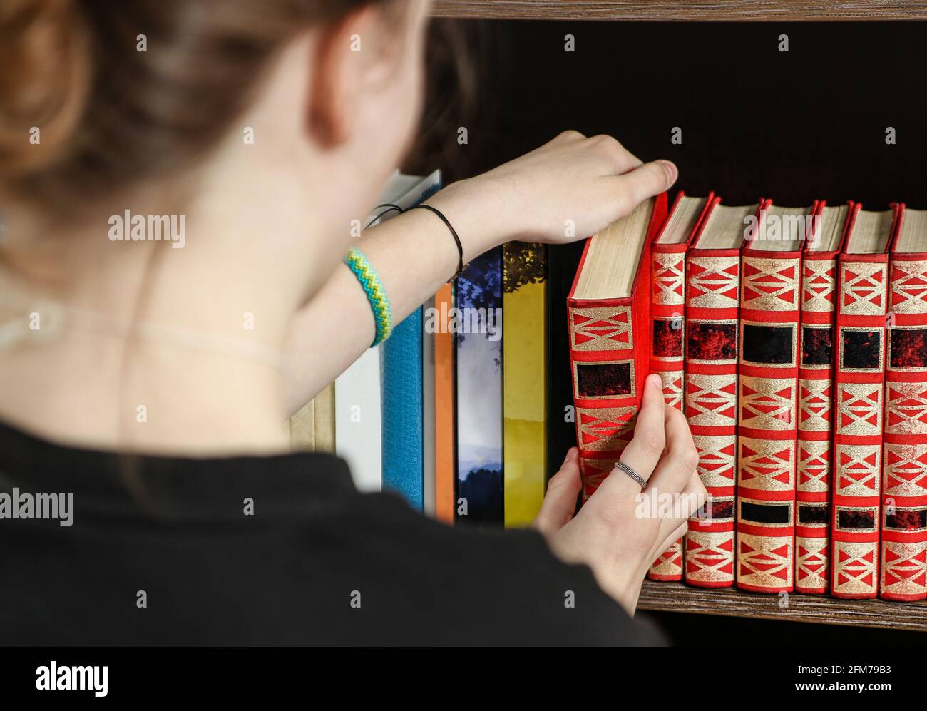 Child picking up book hi-res stock photography and images - Alamy