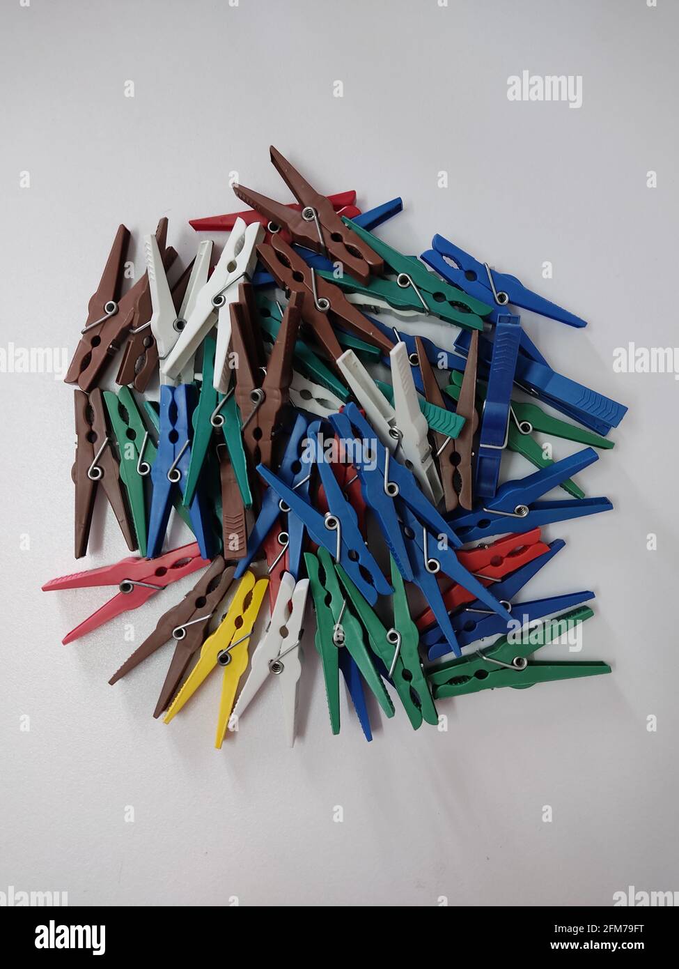 Top view of a heap of colorful clothespins on the light surface Stock ...
