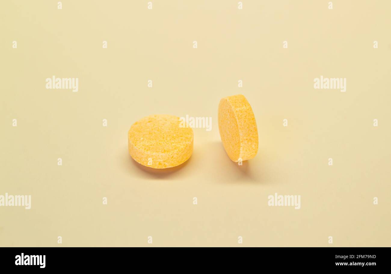Yellow medical pills on a yellow background.Medical concept, Vitamin C ...