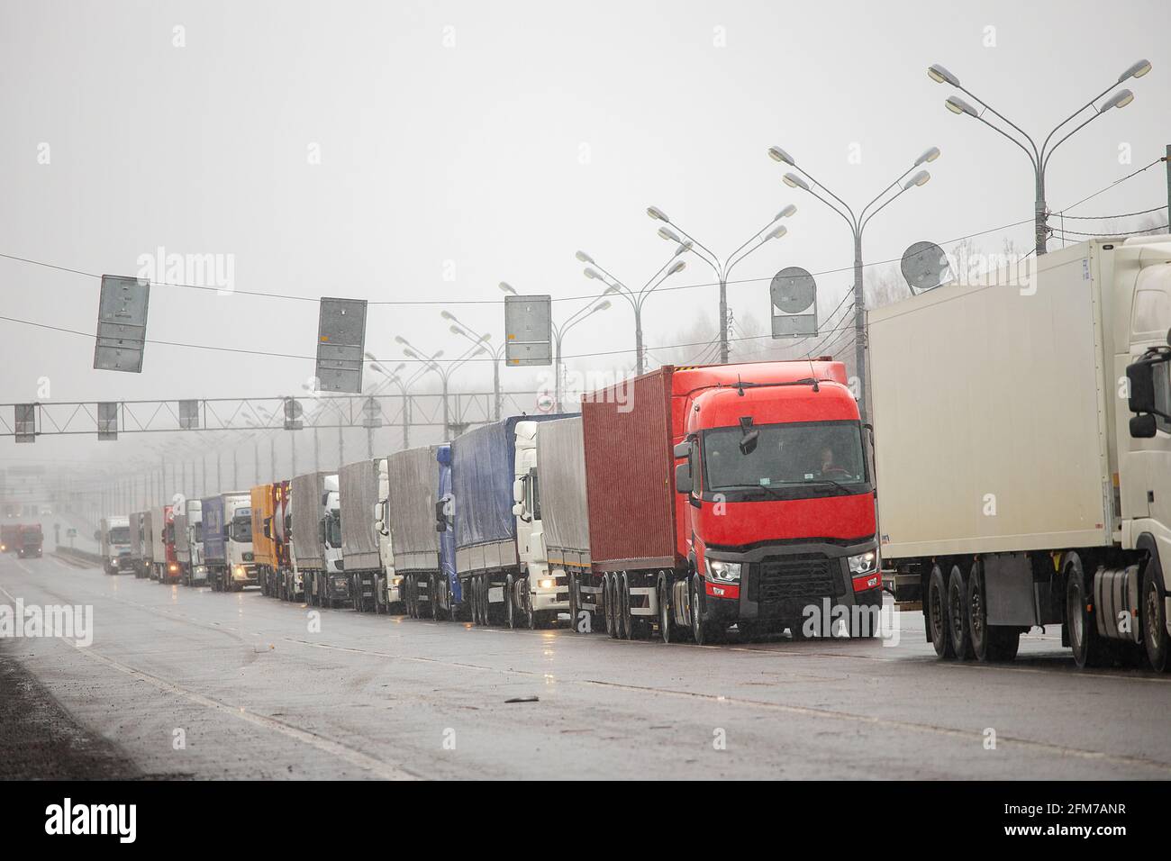a long traffic jam of many trucks at the border , a long wait for ...
