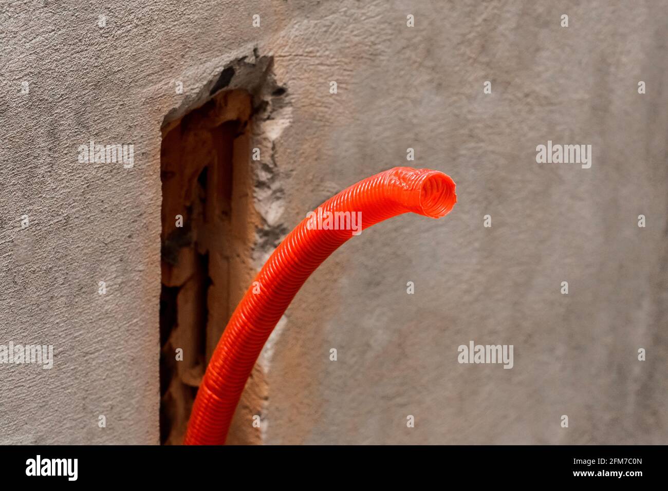 Plastic PVC pipe insulation material on construction concrete home wall ...