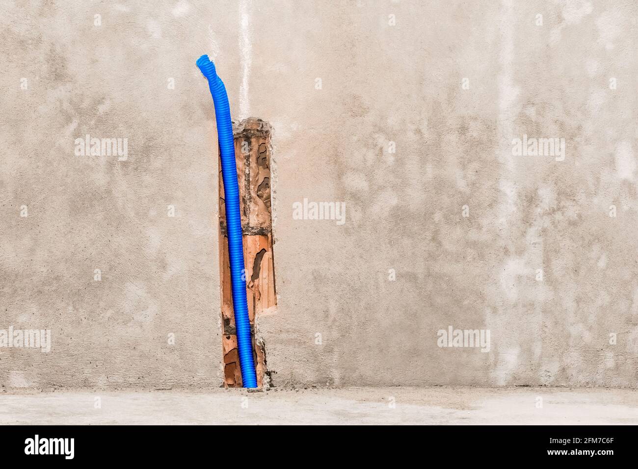 Plastic PVC pipe insulation material on construction concrete home wall ...