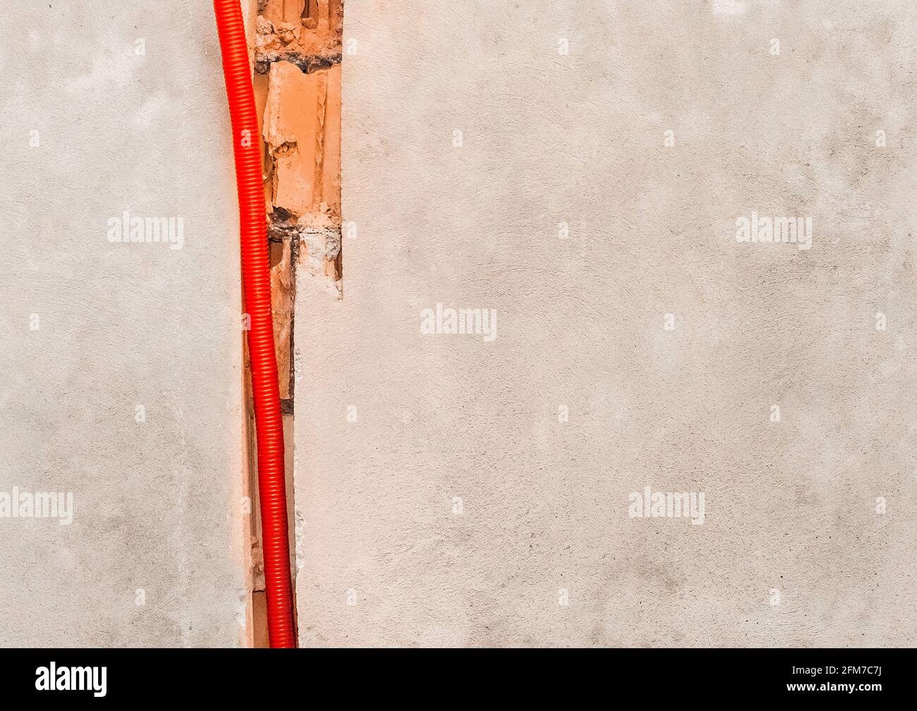 Plastic PVC pipe insulation material on construction concrete home wall ...