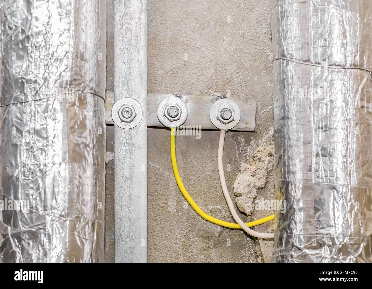 Yellow insulating electric wire cables and metal pipes, construction ...