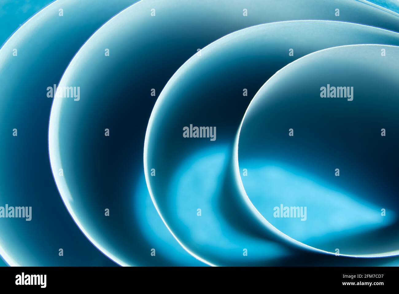 Abstract colored macro background, created with curved blue paper ...