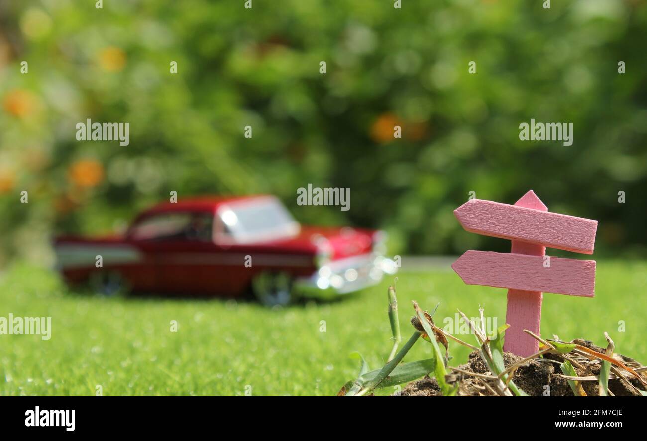 Rustic Signboard in Rural Outdoor Area, Blurred Hot Rod in background ...