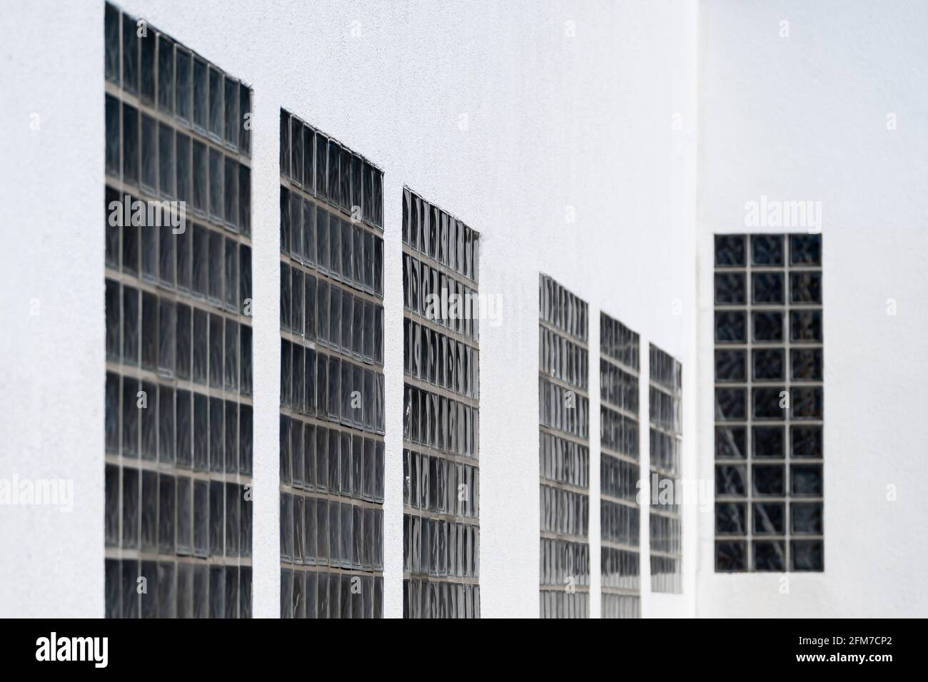 White facade of a craft workshop with glass windows Stock Photo - Alamy