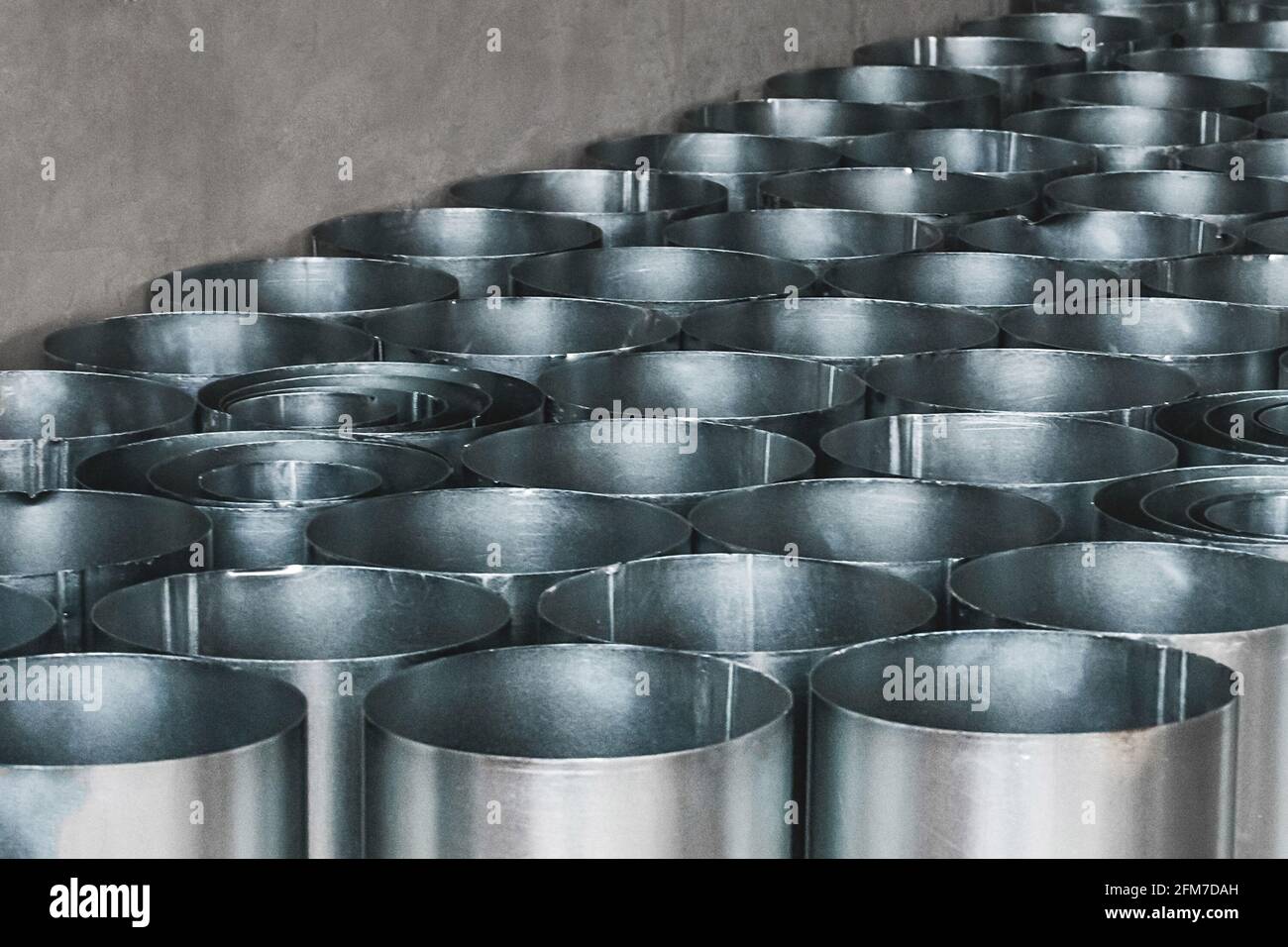 Pile of round metal pipes at a construction site. Storage steel tube ...