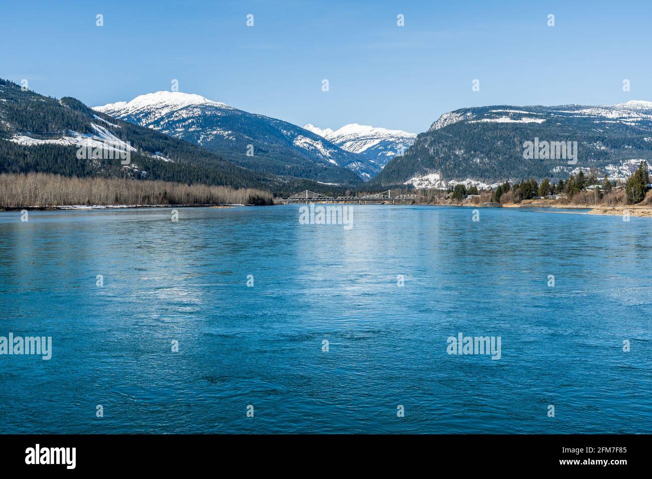 wide Columbia river with snow in mountains blue sky early spring ...