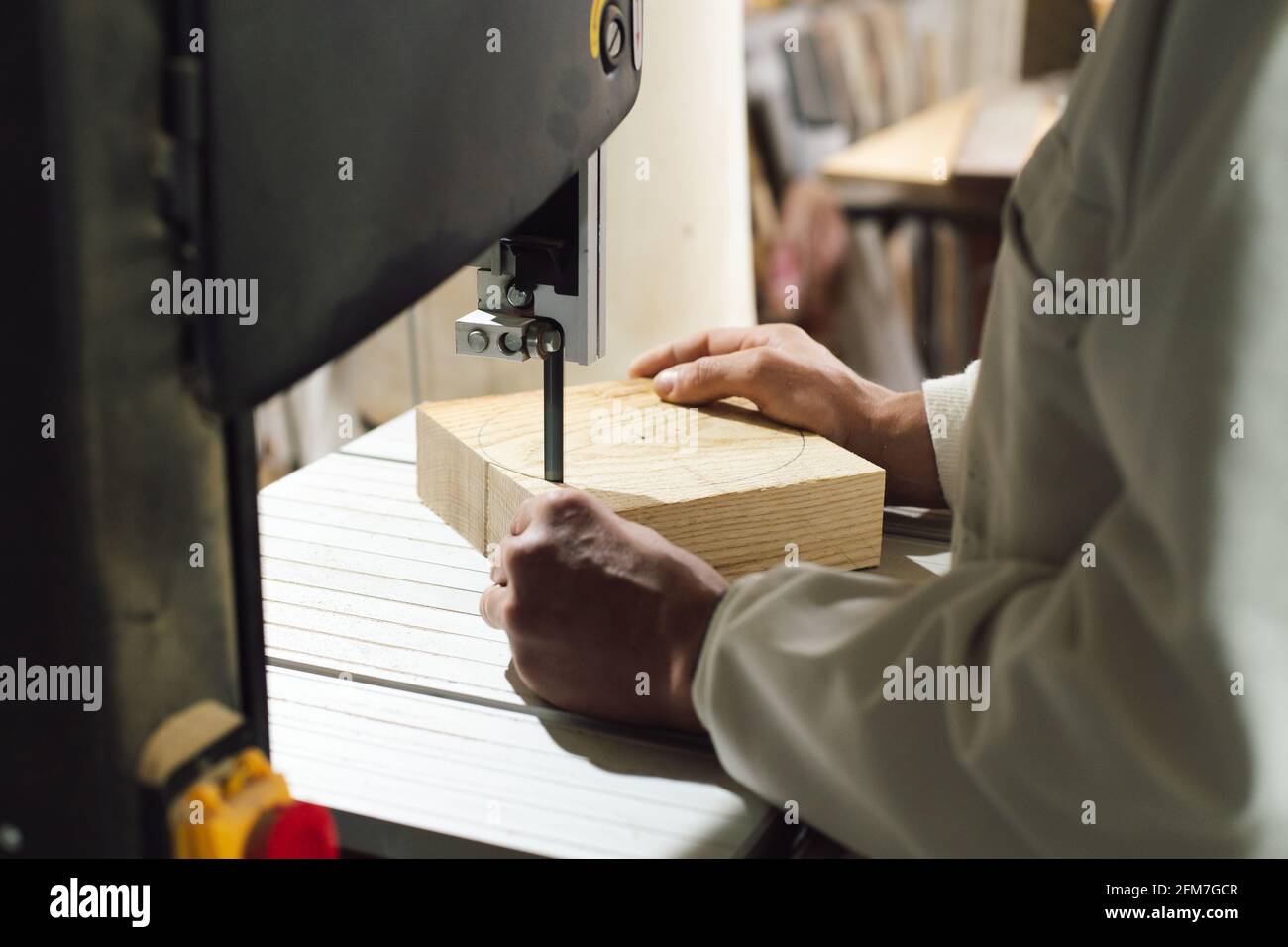 Of a piece of wood being cut by an electrical saw in woodworker's ...