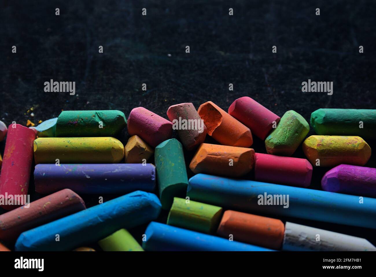 The colorful chalk on chalk board Stock Photo - Alamy