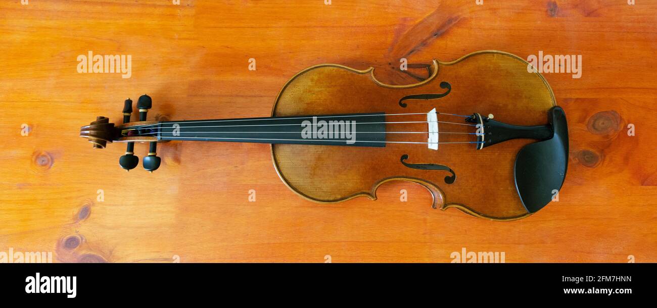 Vertical shot of a well-made violin on a wooden background Stock Photo ...