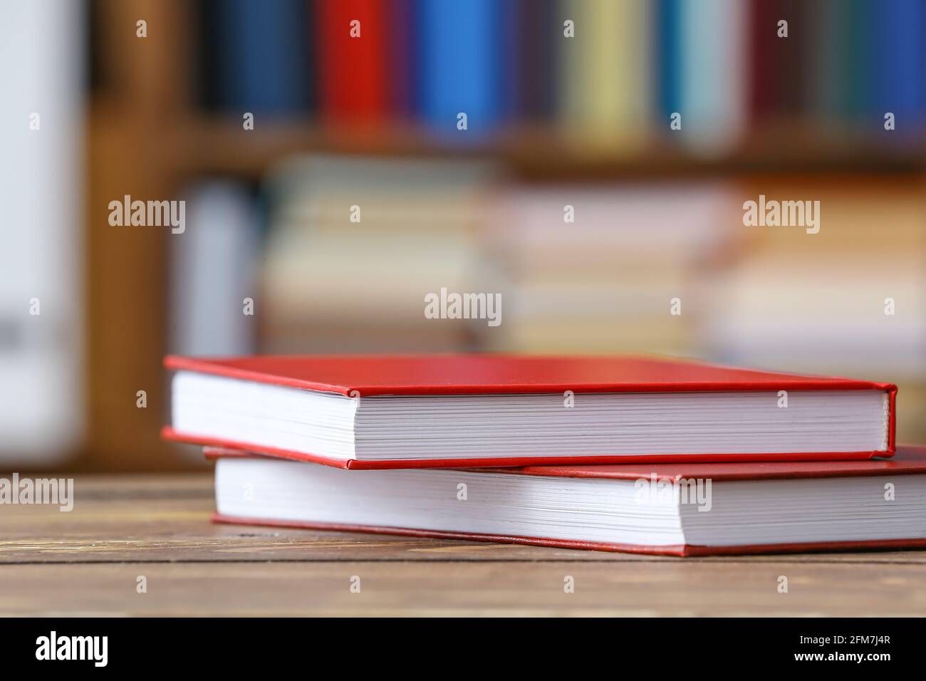 Books on table in library Stock Photo - Alamy