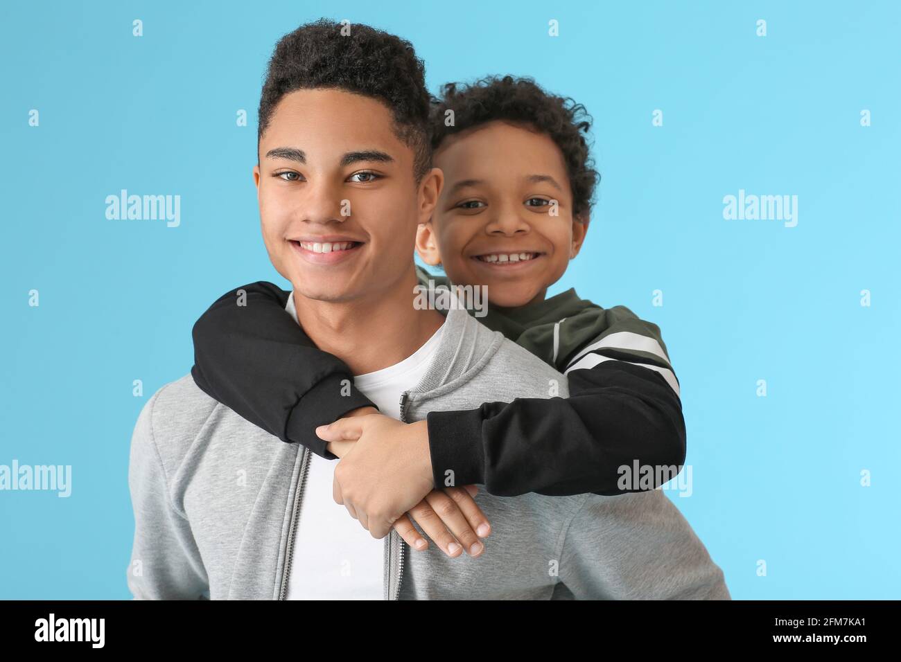 Portrait of African-American brothers on color background Stock Photo ...