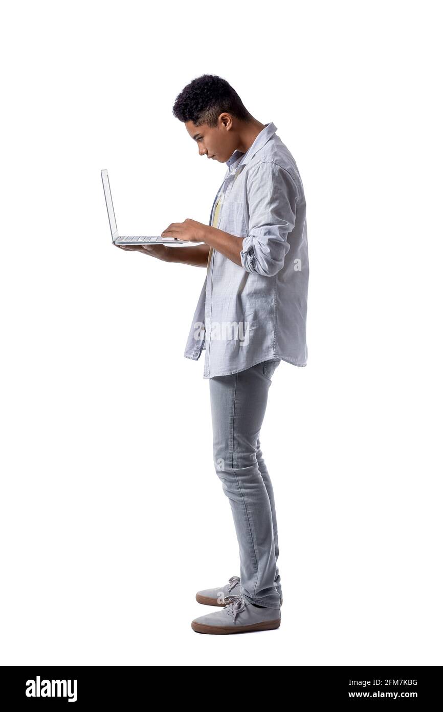 Teenage boy with bad posture using laptop on white background Stock ...