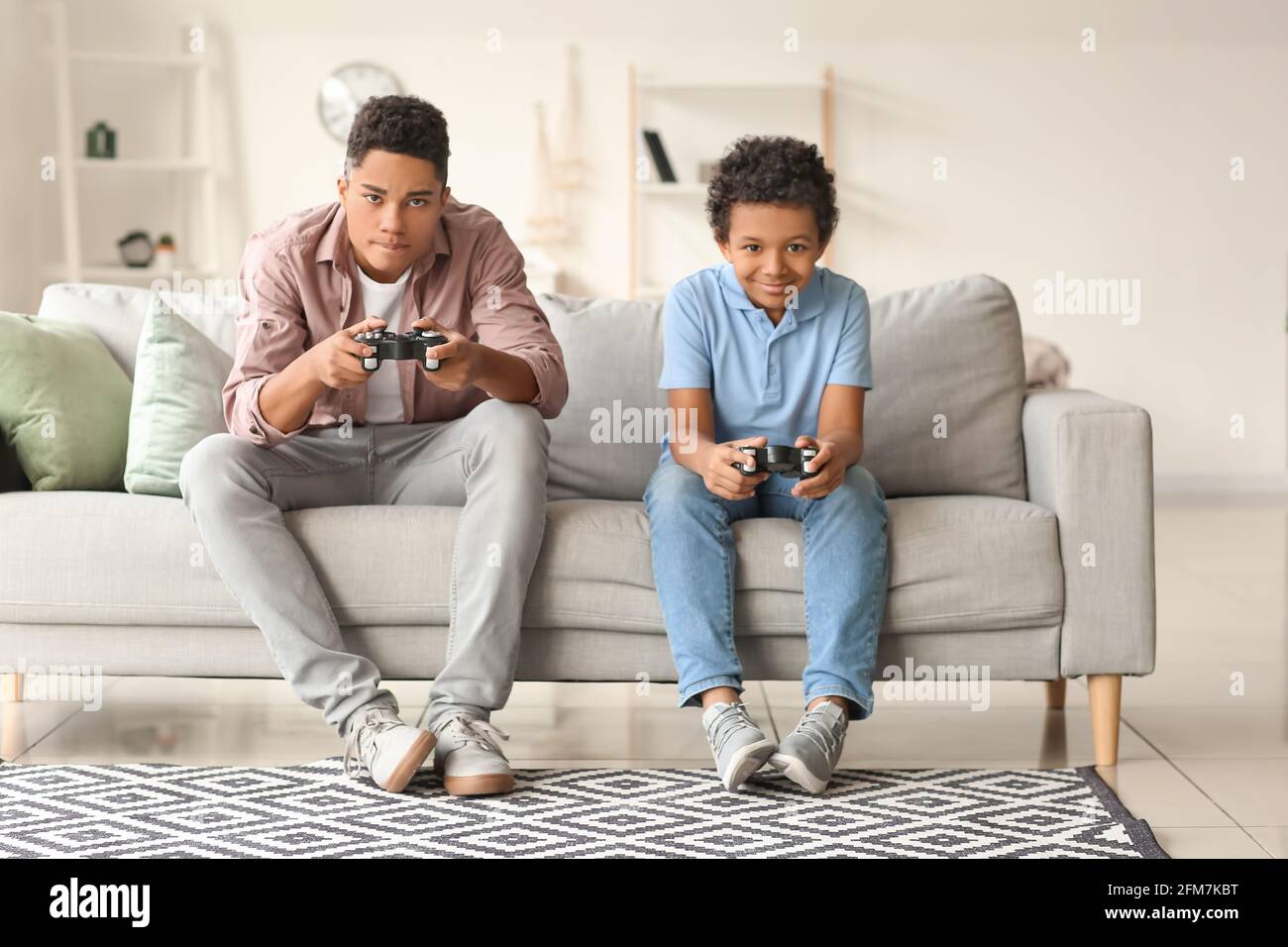 African-American boys playing video game at home Stock Photo - Alamy