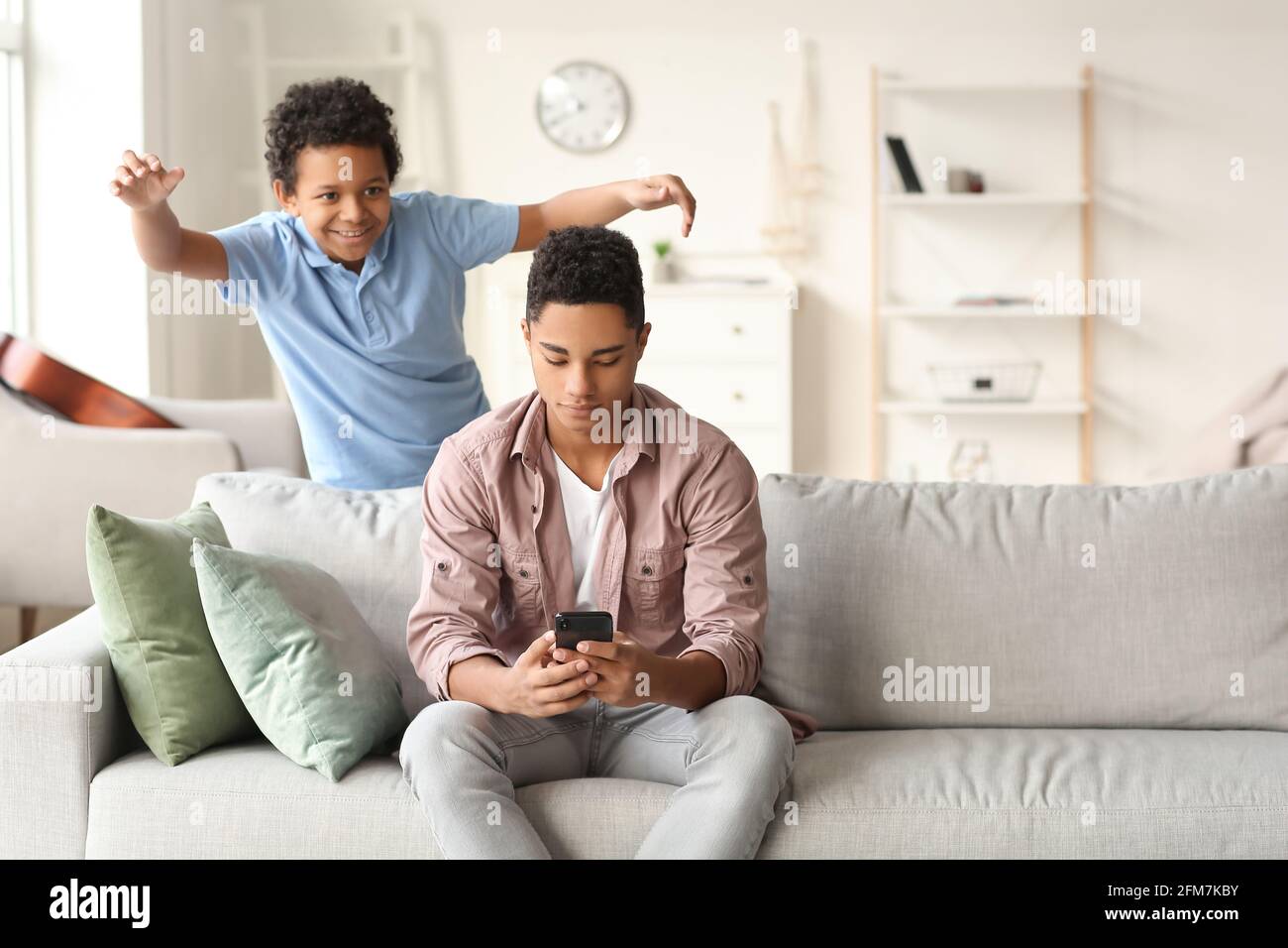 Little boy playing a prank on his brother at home Stock Photo - Alamy