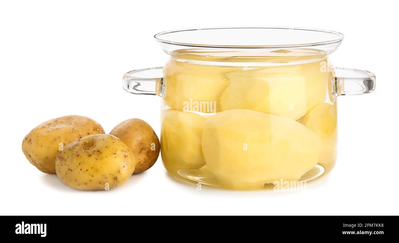Cooking pot with peeled and raw potatoes on white background Stock ...