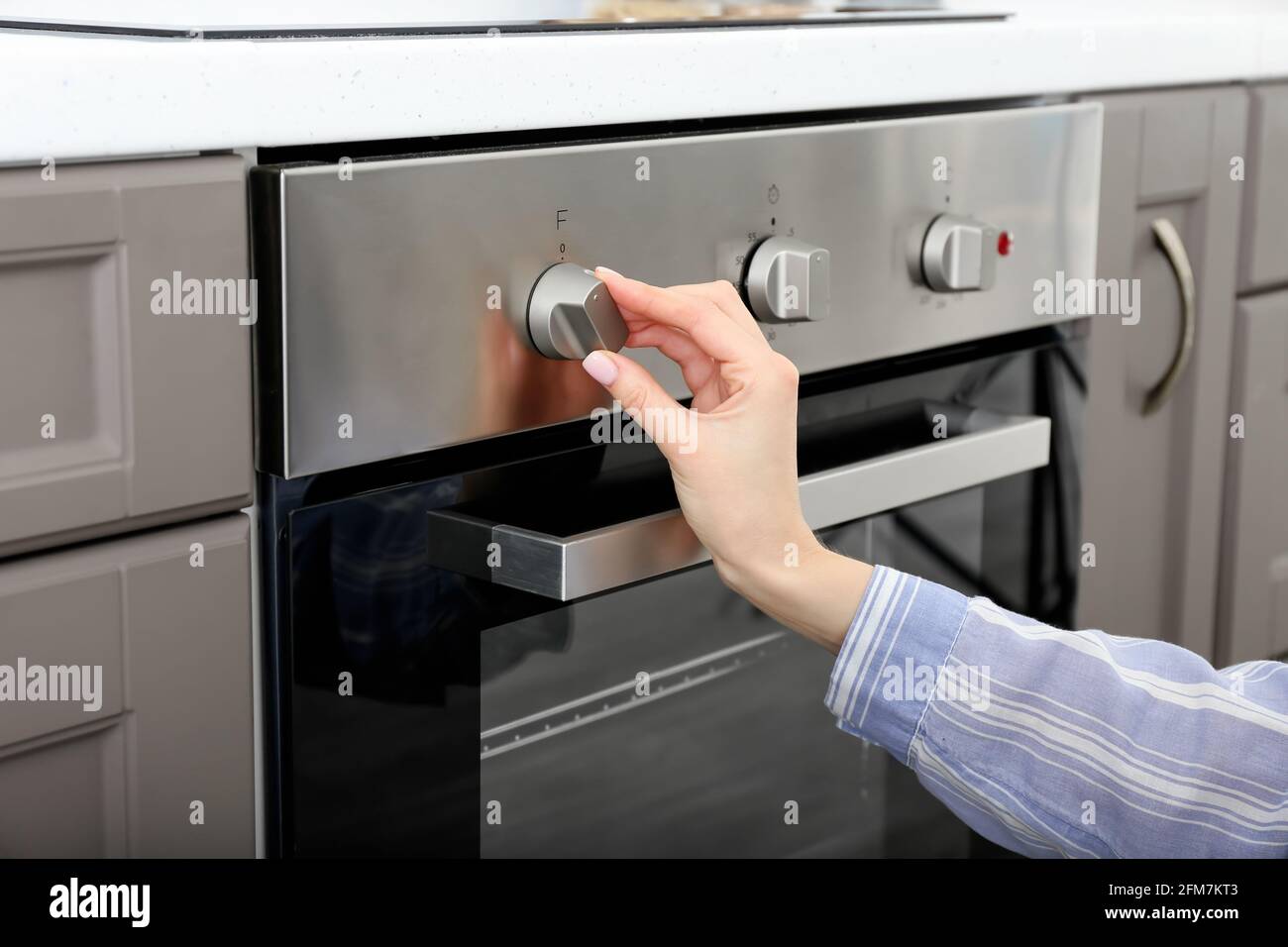 Female hand adjusting electric oven hi-res stock photography and images ...