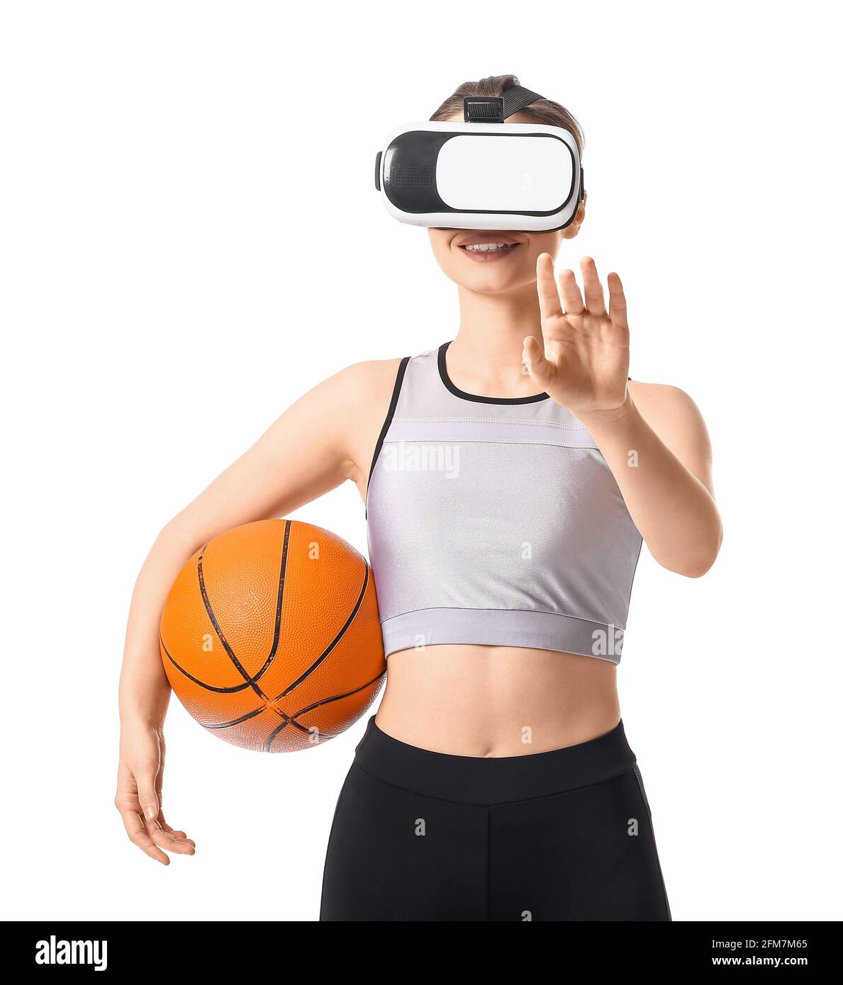 Sporty young woman with virtual reality glasses playing basketball on ...