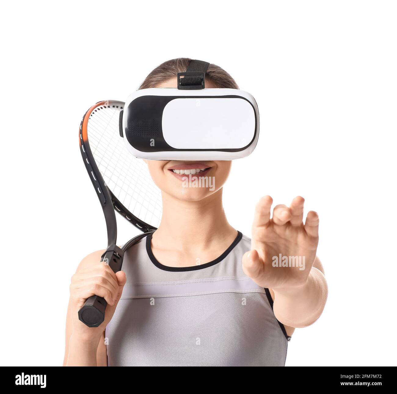 Sporty young woman with virtual reality glasses playing tennis on white ...