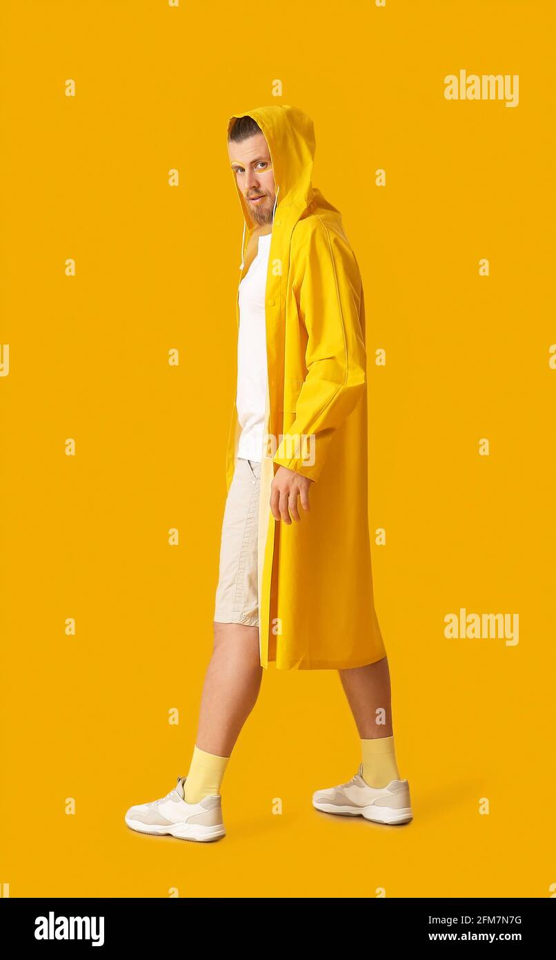 Stylish young man on yellow background Stock Photo - Alamy