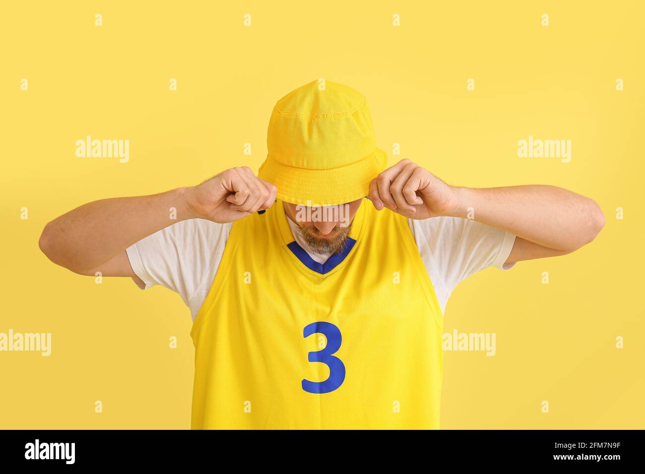 Stylish young man on yellow background Stock Photo - Alamy