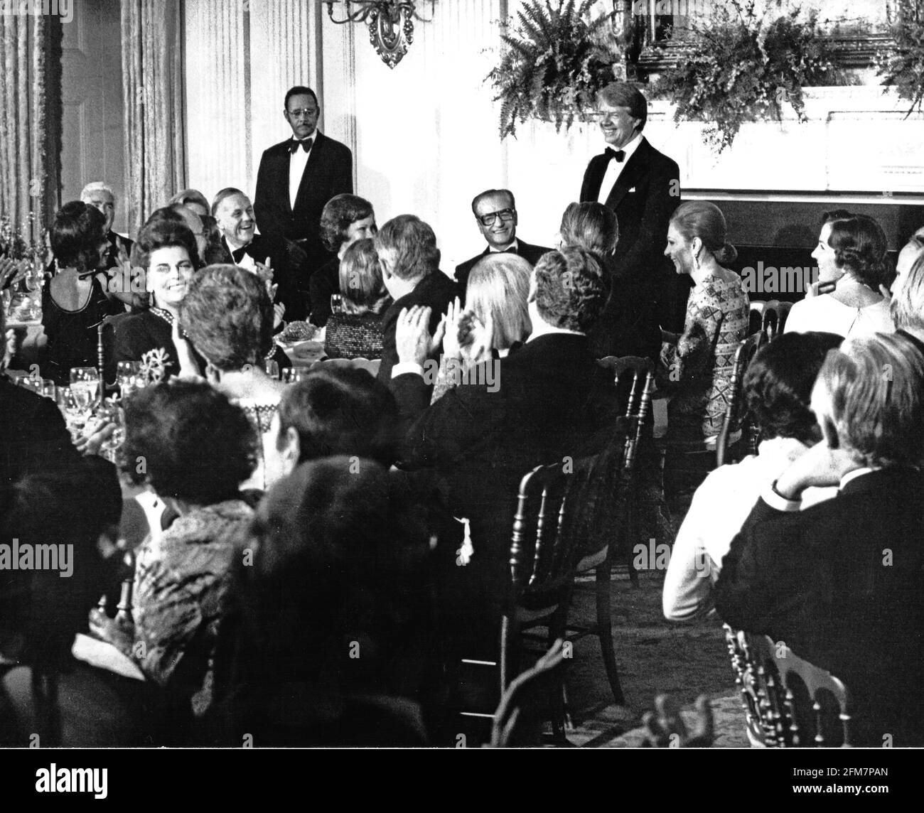 United States President Jimmy Carter, standing right, offers a toast to ...