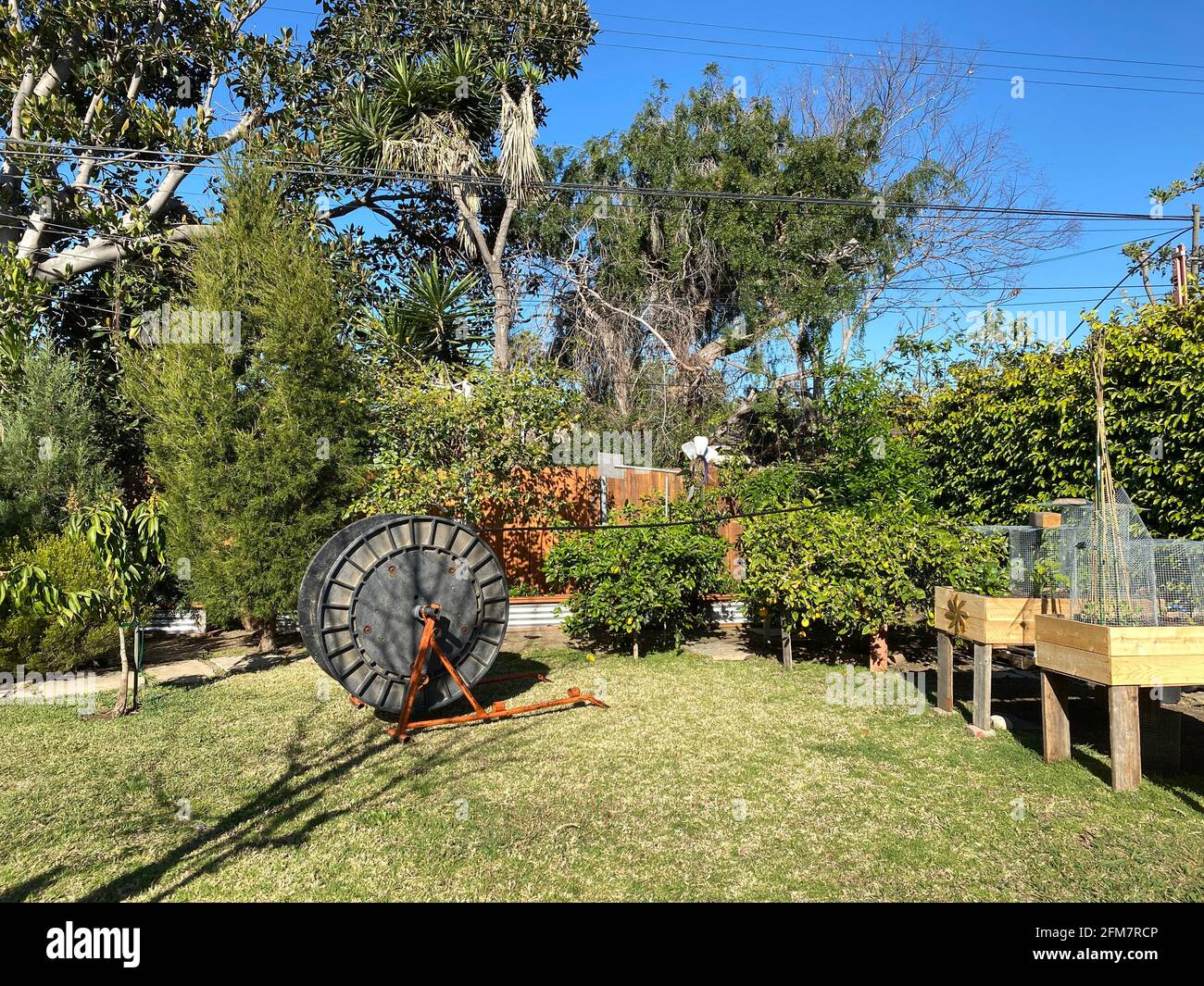 Installing large spools of cable wire along telephone polls in ...