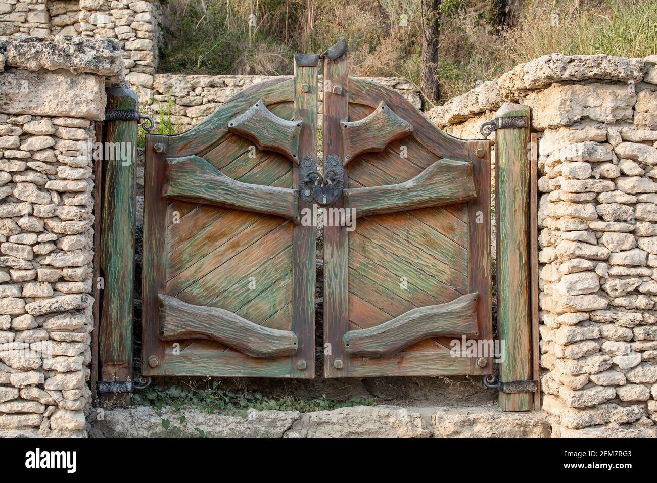 massive wooden gate with large hinged iron lock Stock Photo - Alamy
