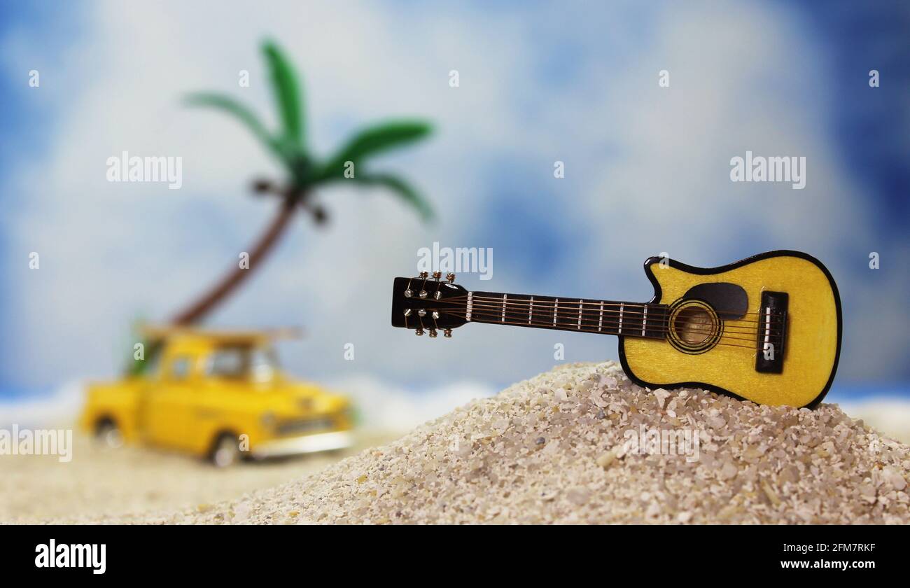 Guitar on Tropical Beach With Palm Trees in Background Stock Photo - Alamy