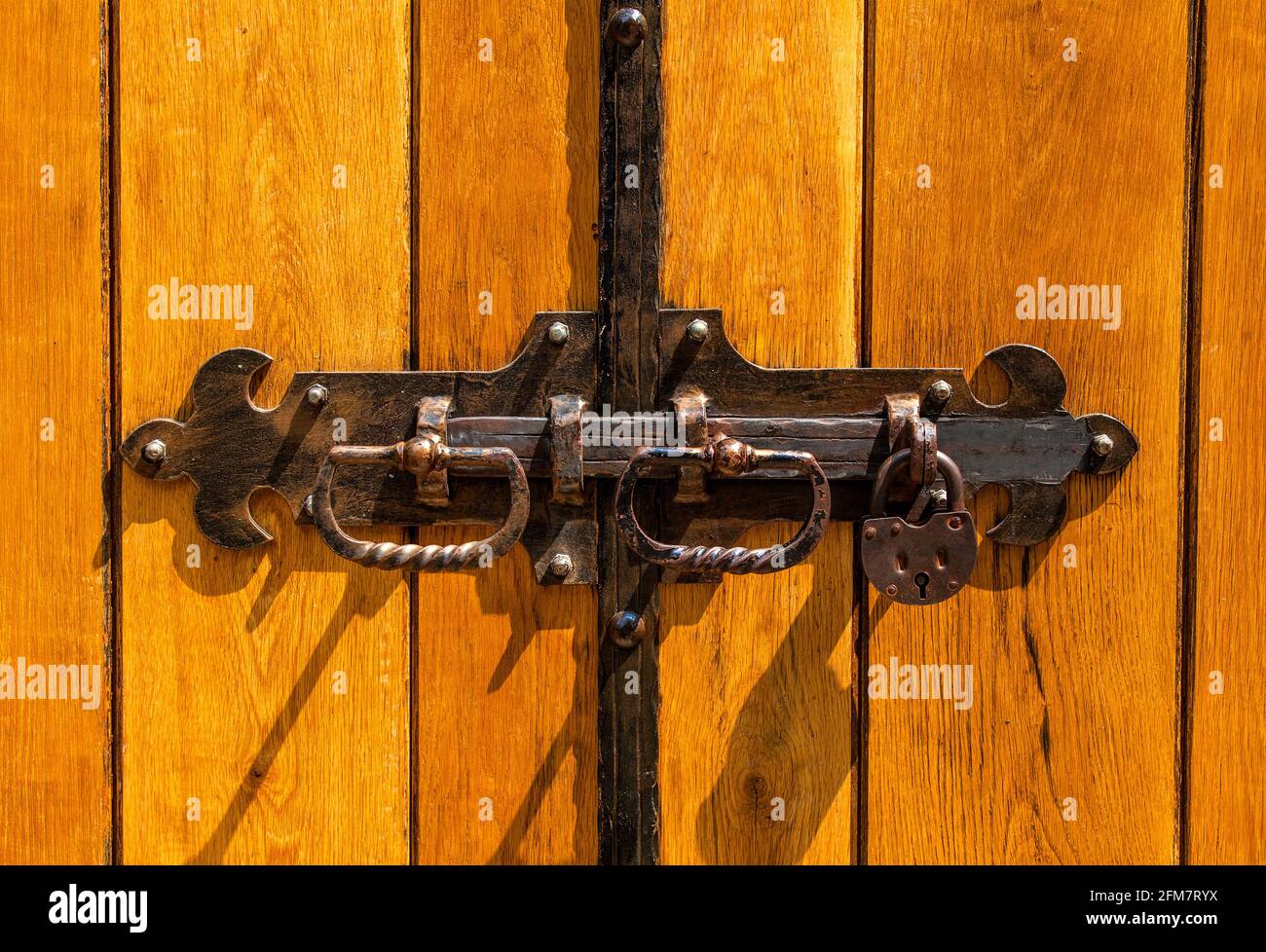 wrought iron lock wooden door Stock Photo - Alamy
